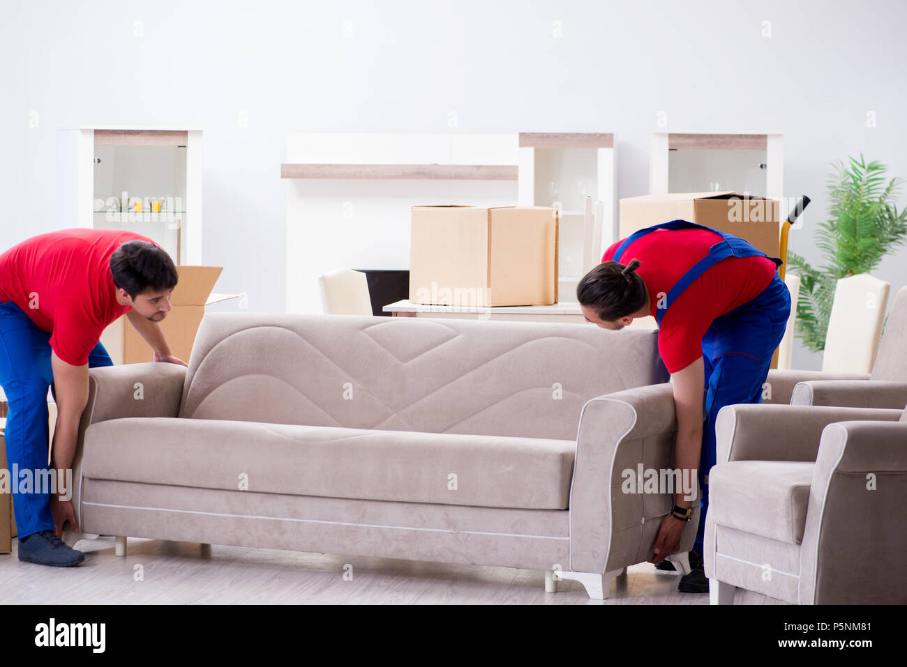 Two contractor employees moving personal belongings Stock Photo - Alamy