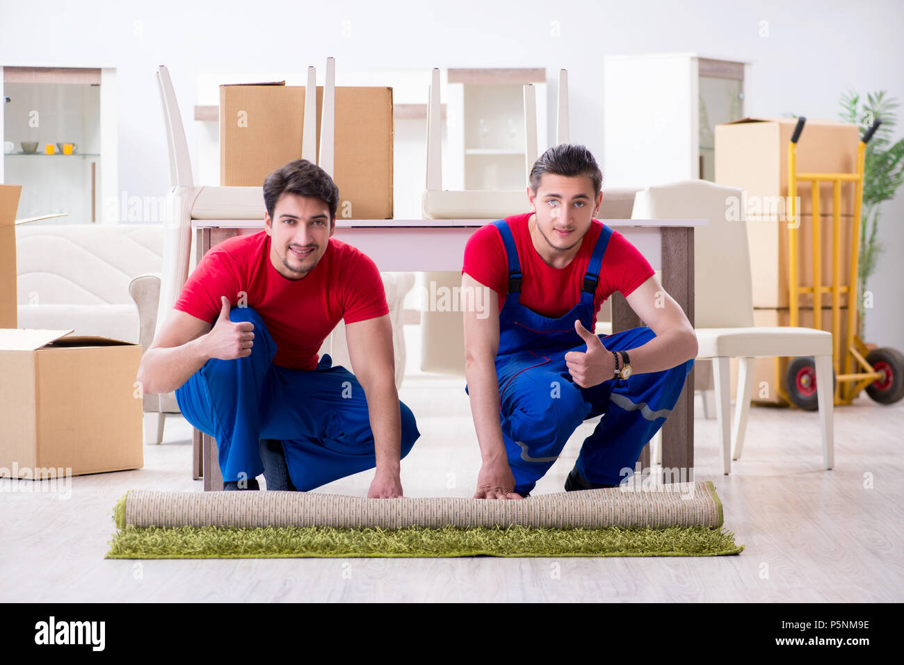 Two contractor employees moving personal belongings Stock Photo - Alamy