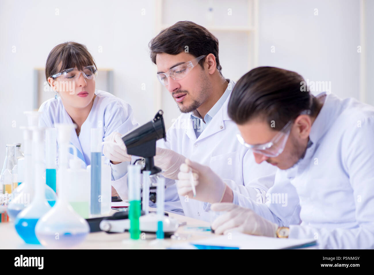 Team of chemists working in the lab Stock Photo - Alamy