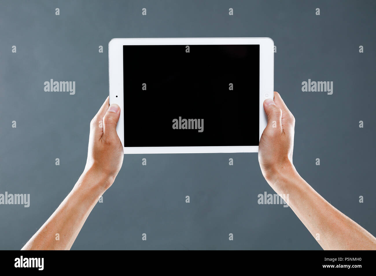Hands holding tablet Stock Photo - Alamy
