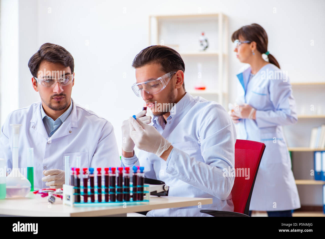 Team of chemists working in the lab Stock Photo - Alamy