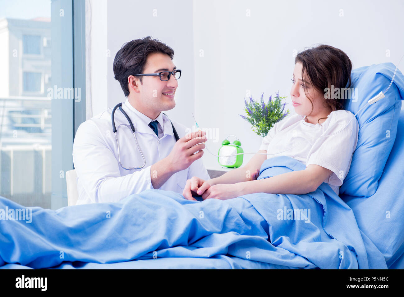 Doctor doing medical injection in hospital room Stock Photo - Alamy