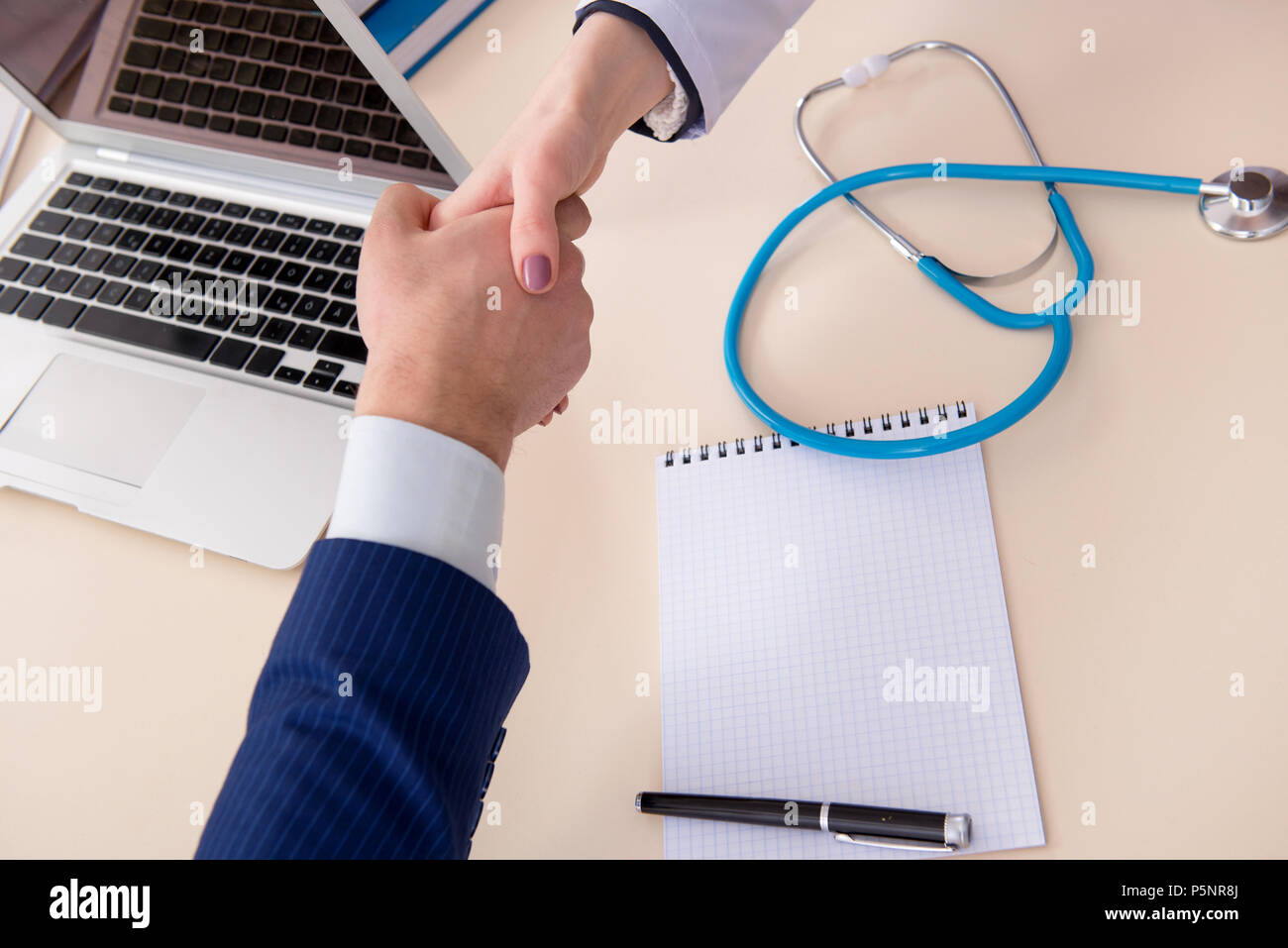 Man signing medical insurance contract Stock Photo - Alamy