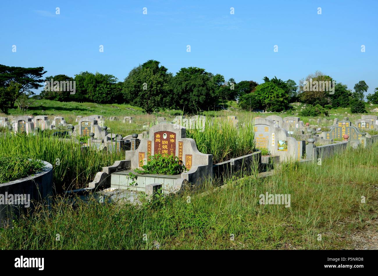General view of large Chinese graveyard cemetery with graves and ...