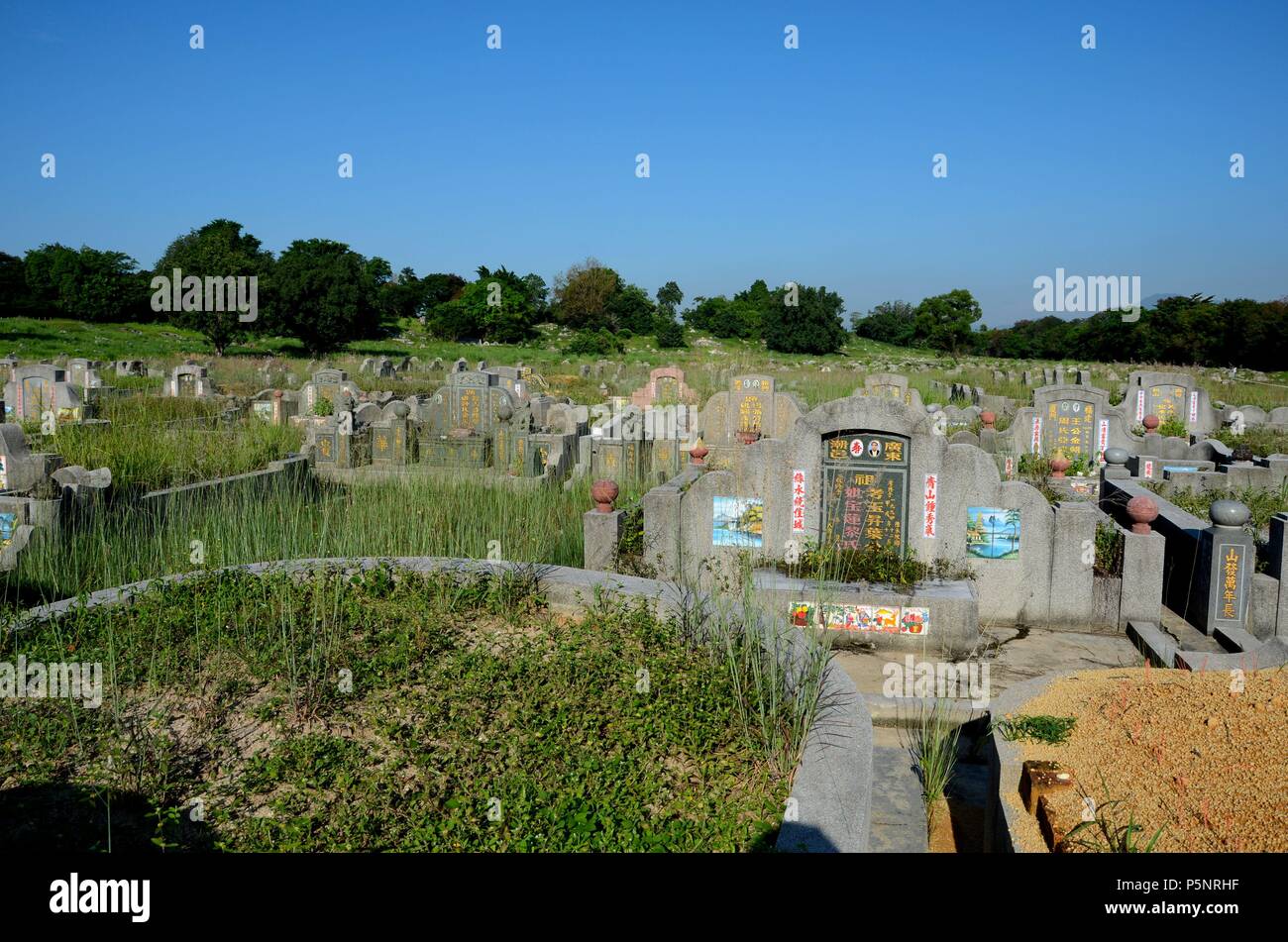 General view of large Chinese graveyard cemetery with graves and ...