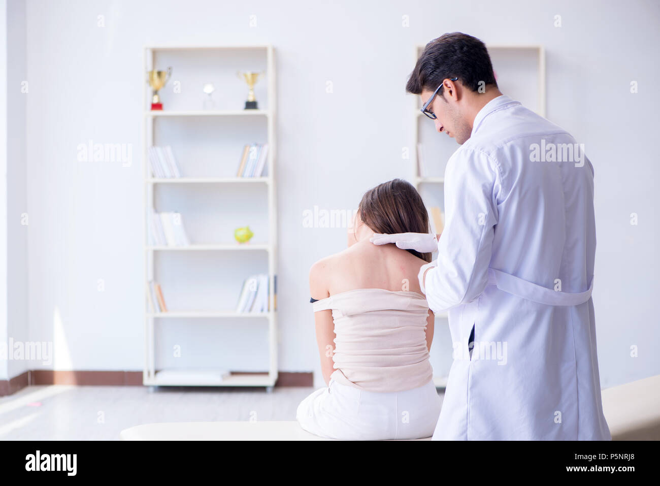 Doctor examining the skin of female patient Stock Photo - Alamy