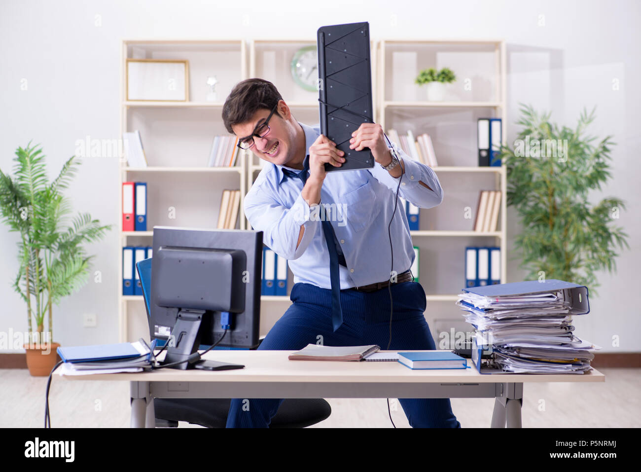 Angry businessman frustrated with too much work Stock Photo - Alamy