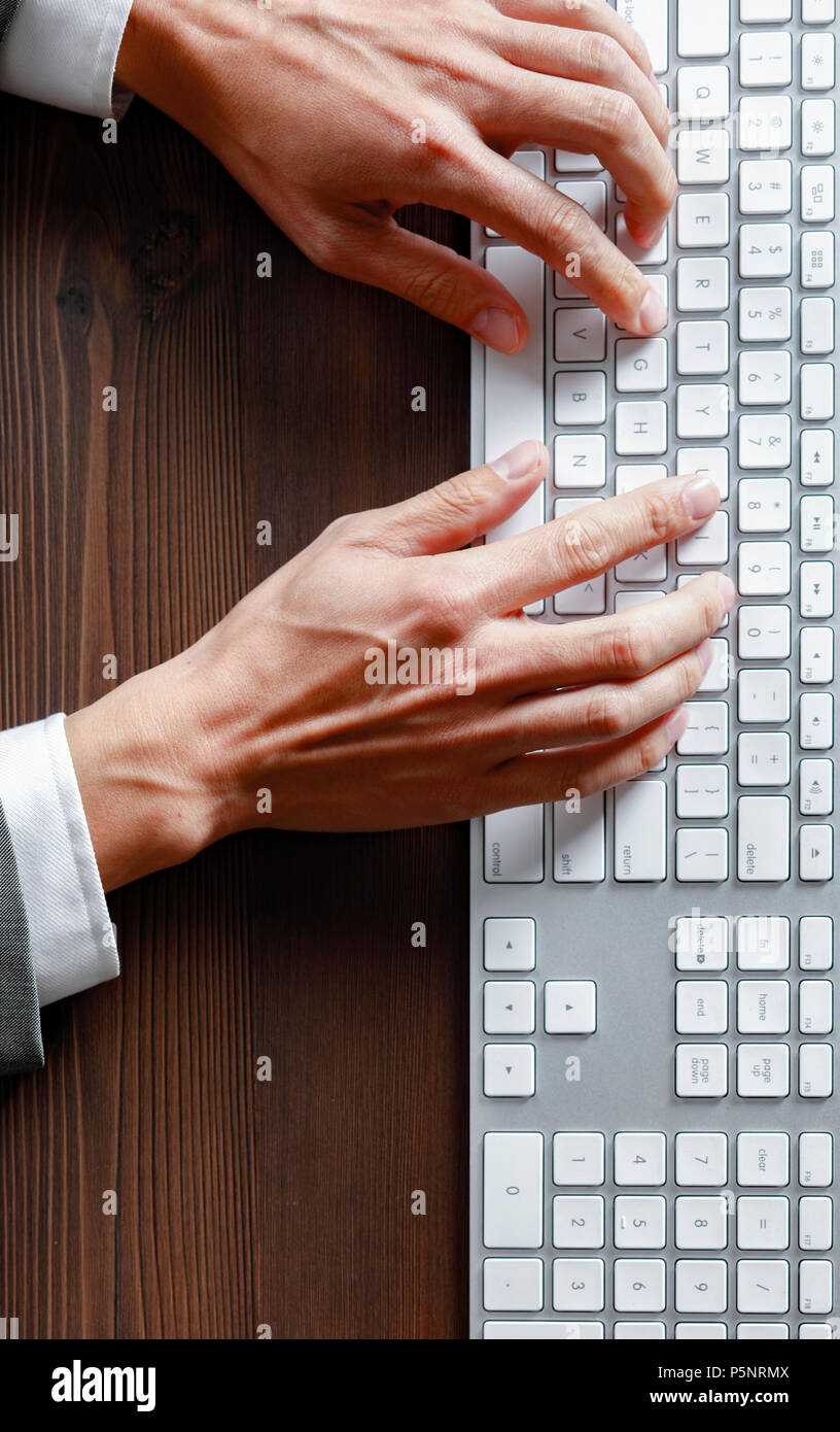 Male hands working on keyboard Stock Photo - Alamy