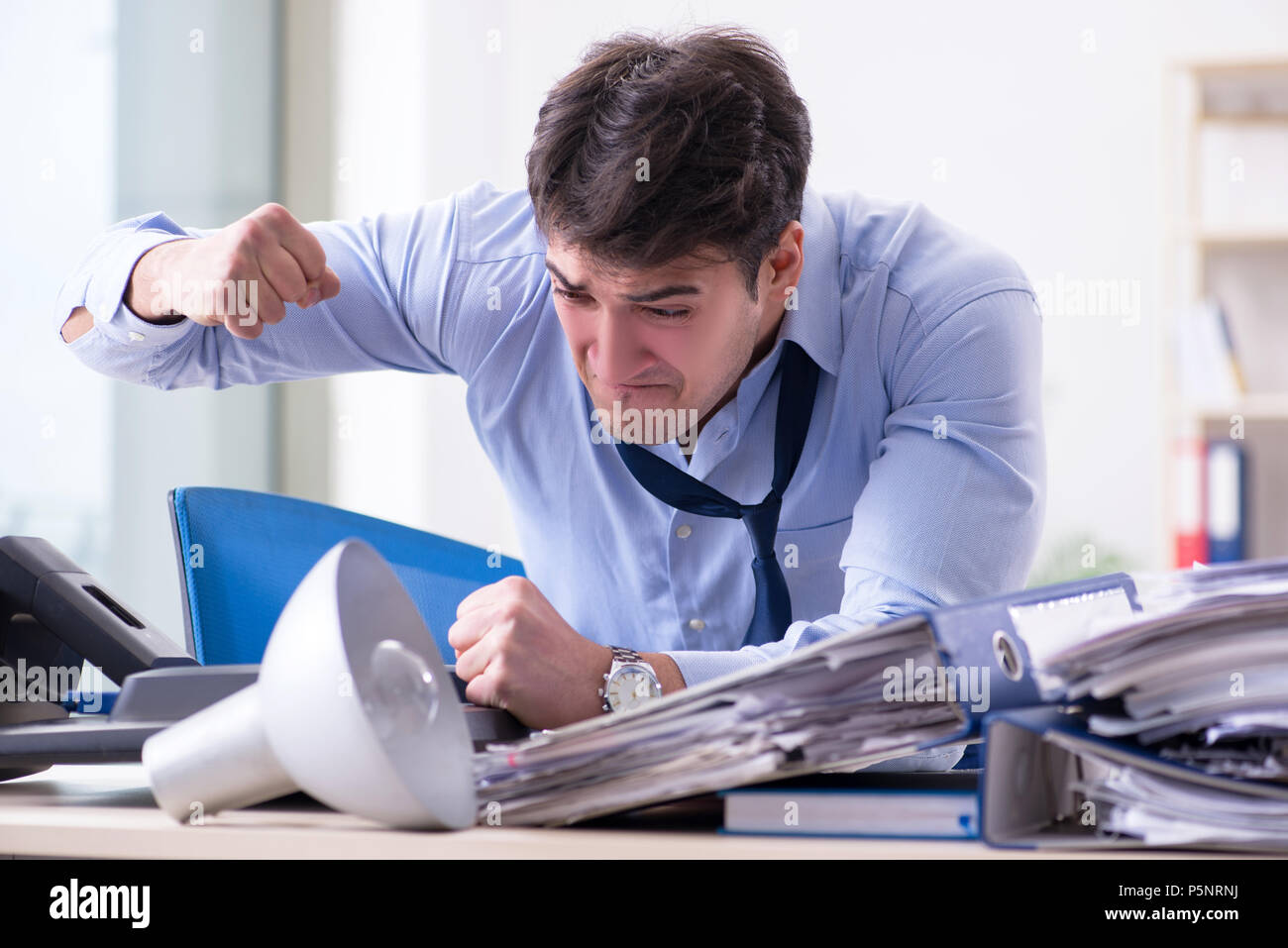 Angry businessman frustrated with too much work Stock Photo - Alamy
