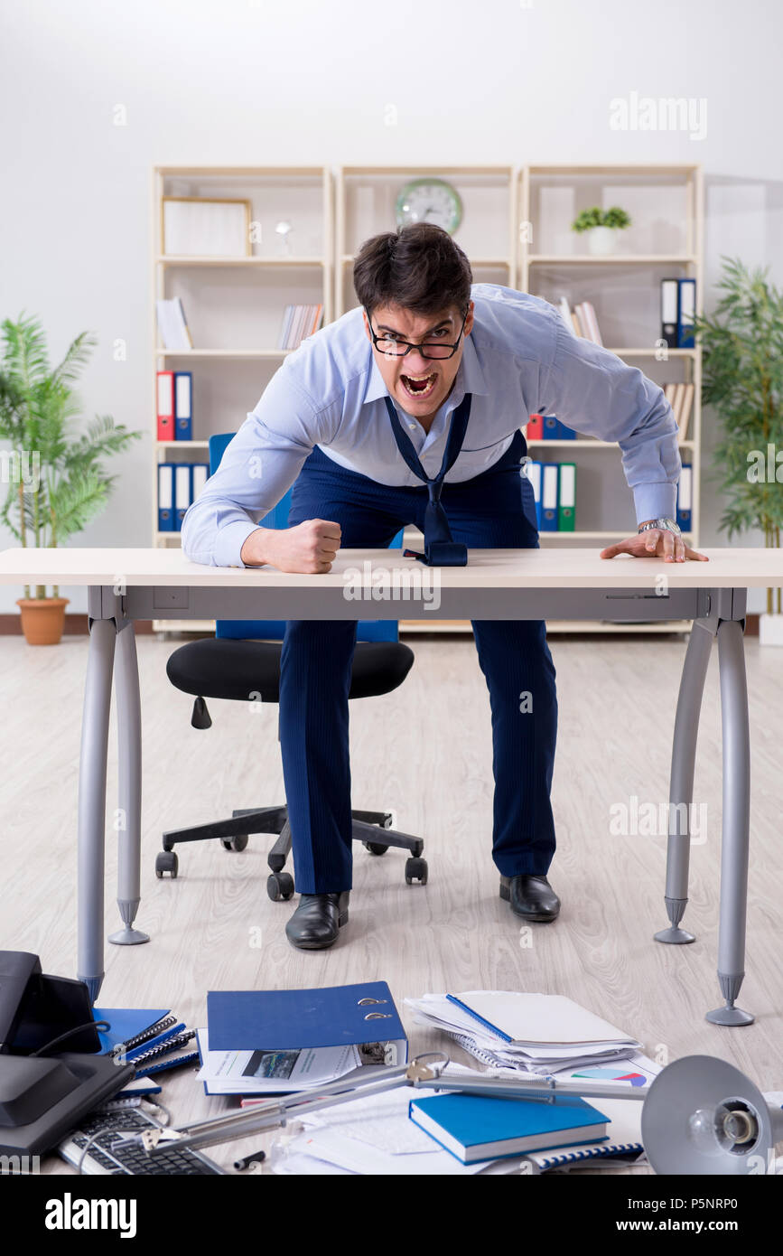 Angry businessman frustrated with too much work Stock Photo - Alamy