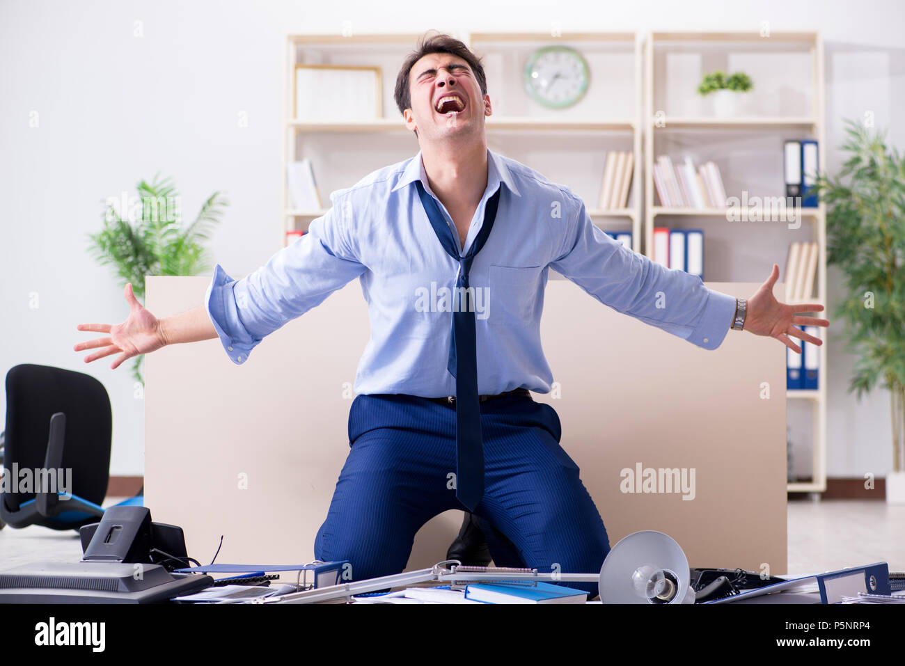 Angry businessman frustrated with too much work Stock Photo - Alamy