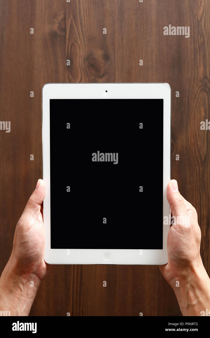 Hands holding tablet Stock Photo - Alamy