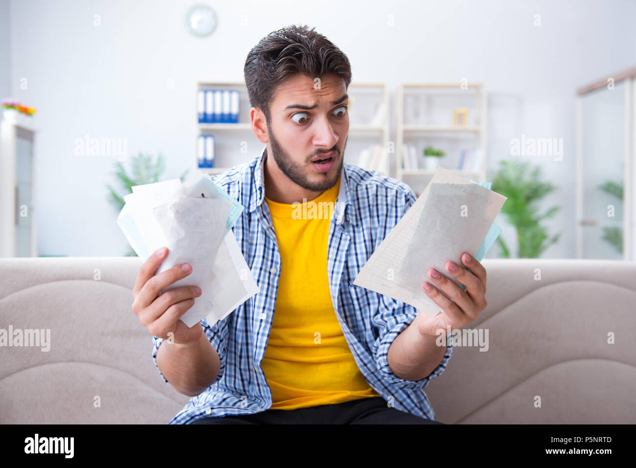 Man angry at bills he needs to pay Stock Photo - Alamy