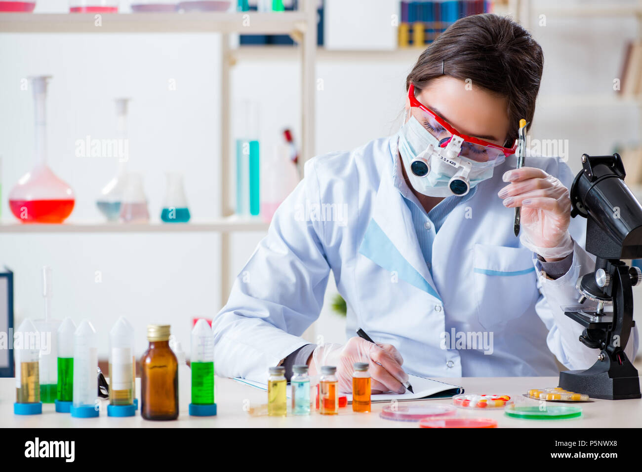 Lab assistant in drug synthesis concept Stock Photo - Alamy