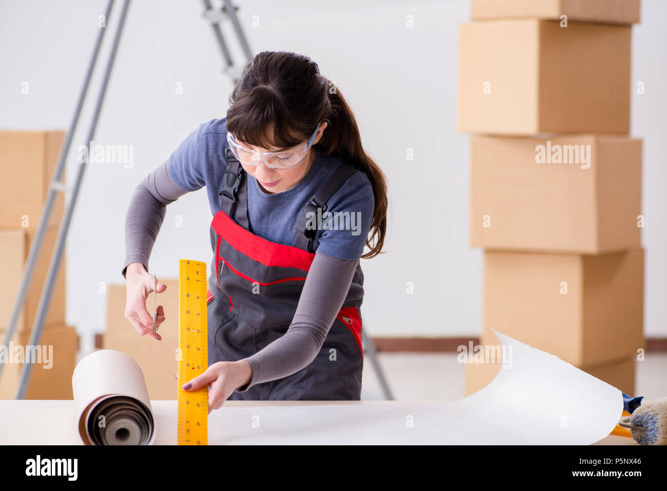 Woman preparing for wallpaper work Stock Photo - Alamy