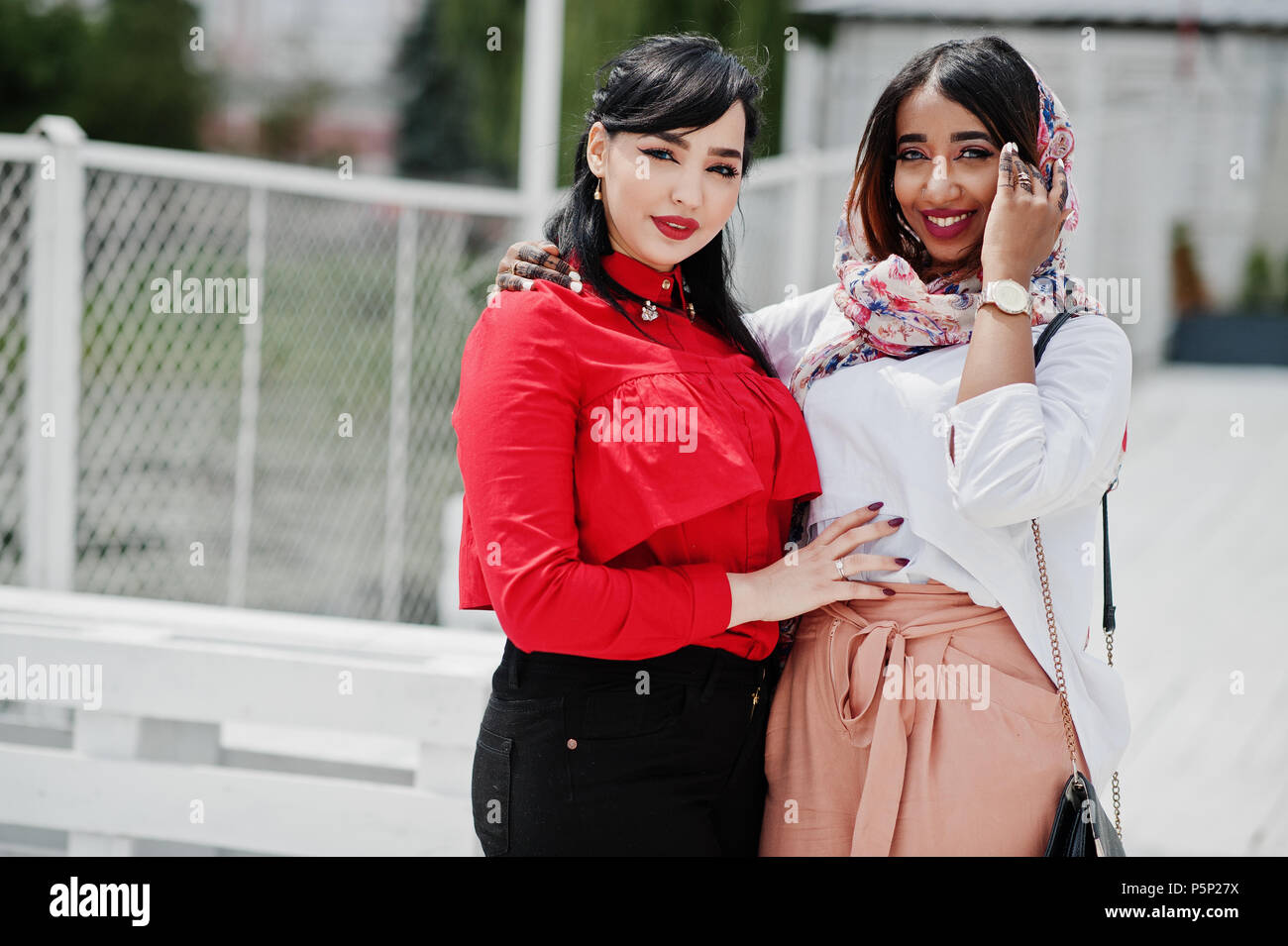 Two fashionable arabian girls friends posed outdoor. Stylish muslim ...