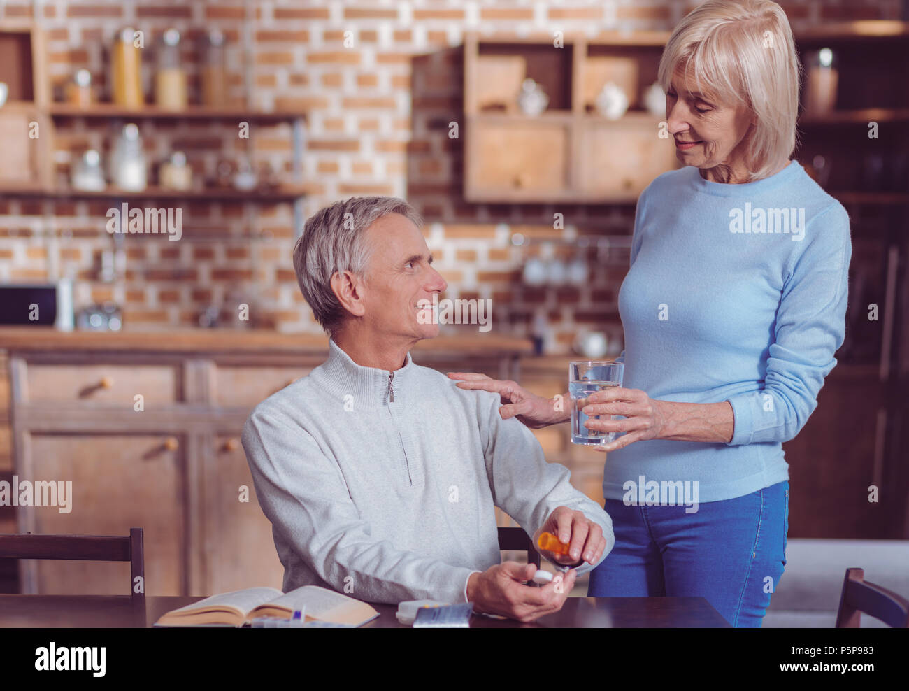 Cheerful senior woman supporting her husband Stock Photo - Alamy