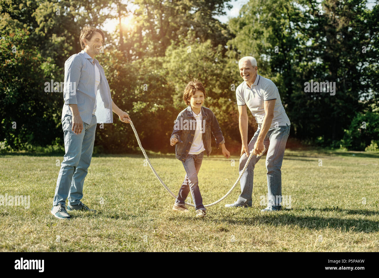 Exuberant boy playing with his family Stock Photo - Alamy