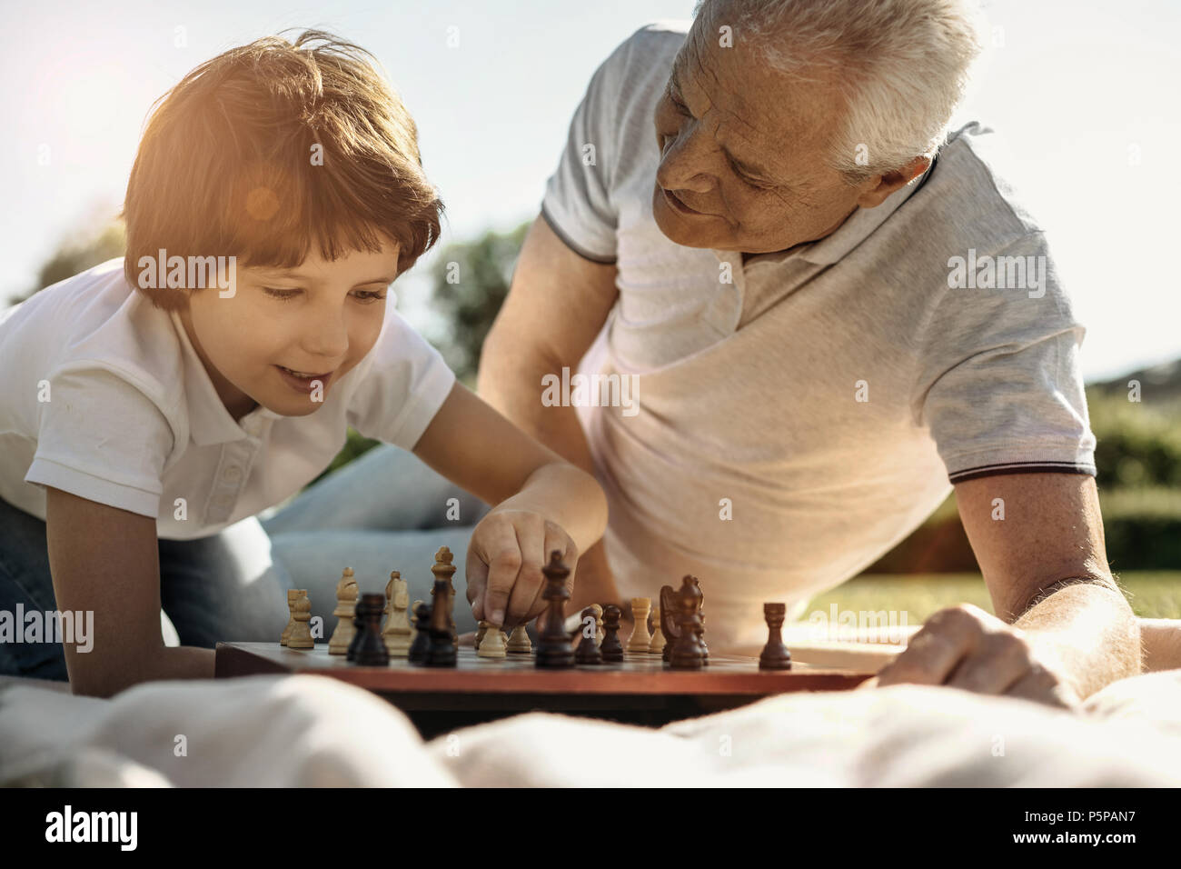 Boy and his grandpa playing chess Stock Photo - Alamy