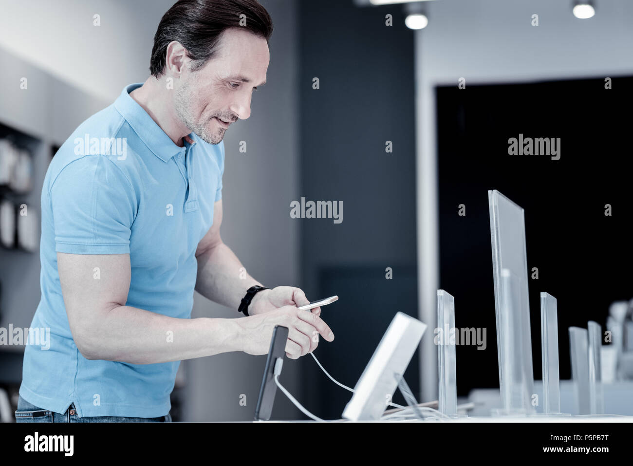 Careful customer in the electronics shop Stock Photo - Alamy