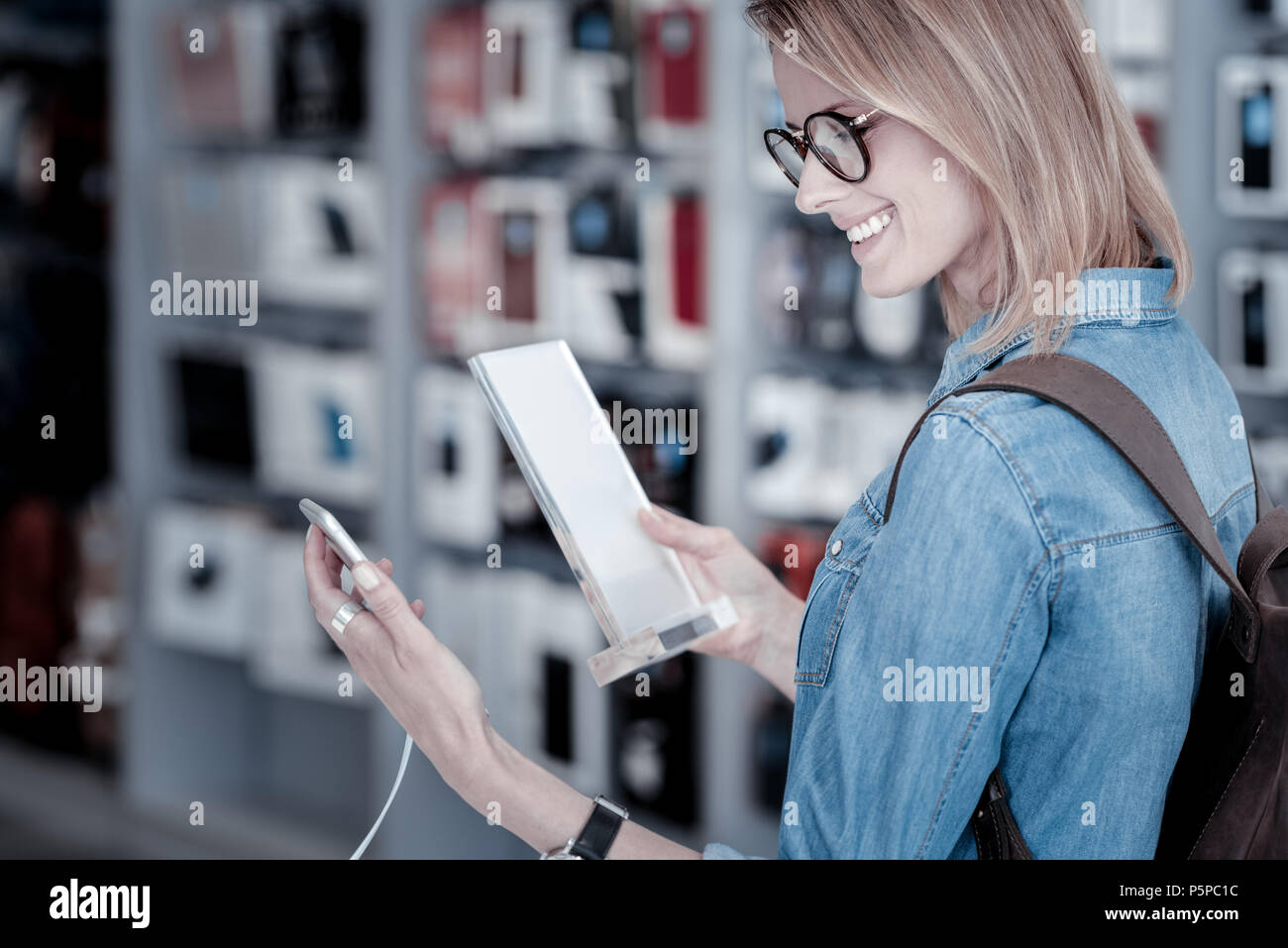 Responsible customer reading a detailed description of a gadget Stock ...