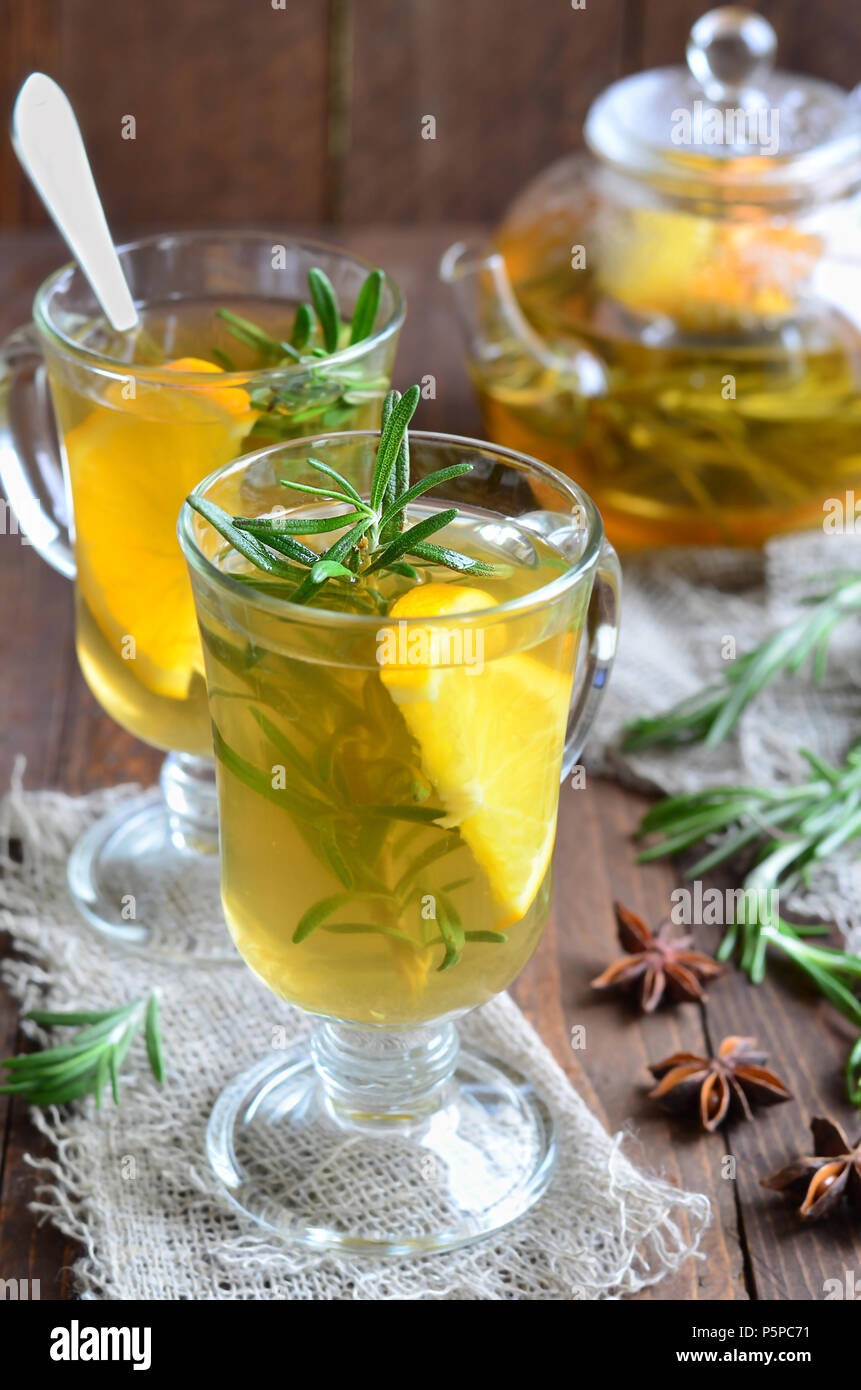 Healthy orange and rosemary tea on wooden background Stock Photo - Alamy
