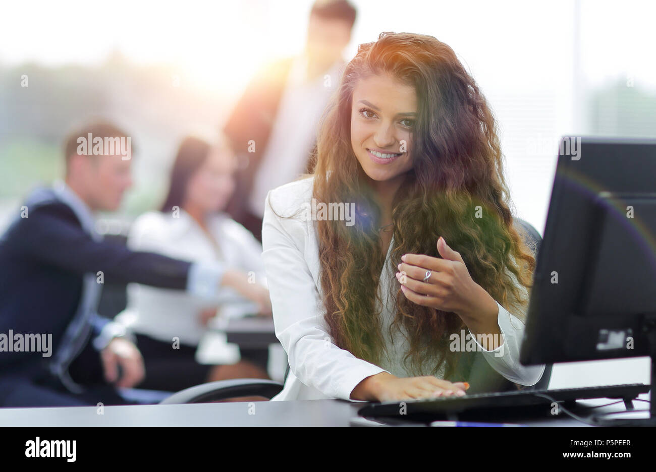 Manager woman sitting behind a Desk Stock Photo - Alamy