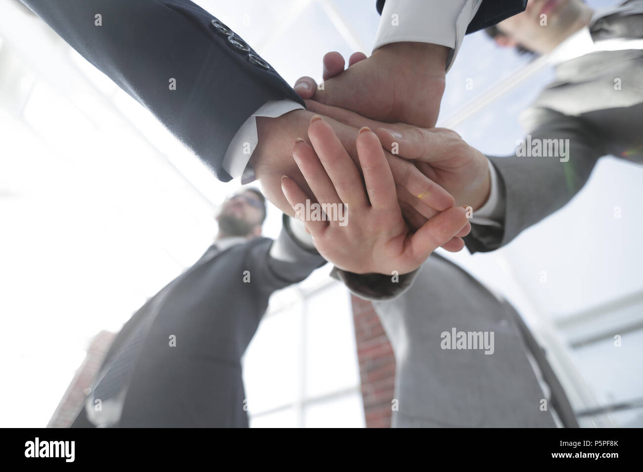 business people folding their hands together Stock Photo - Alamy