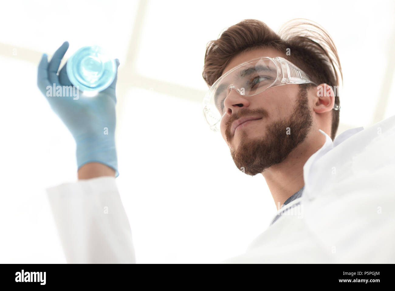 Scientist holding beaker hi-res stock photography and images - Alamy