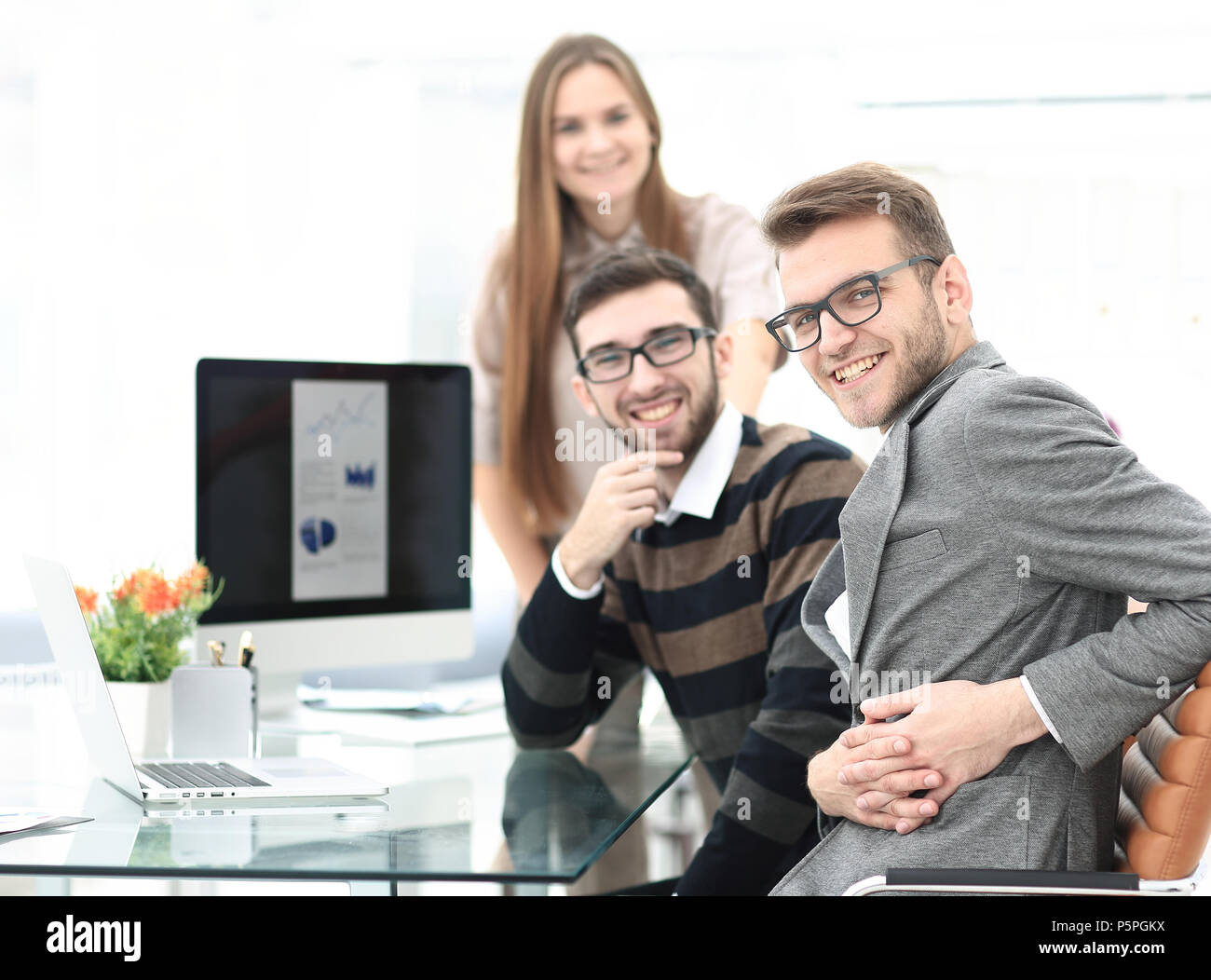 two colleagues sitting at his Desk Stock Photo - Alamy