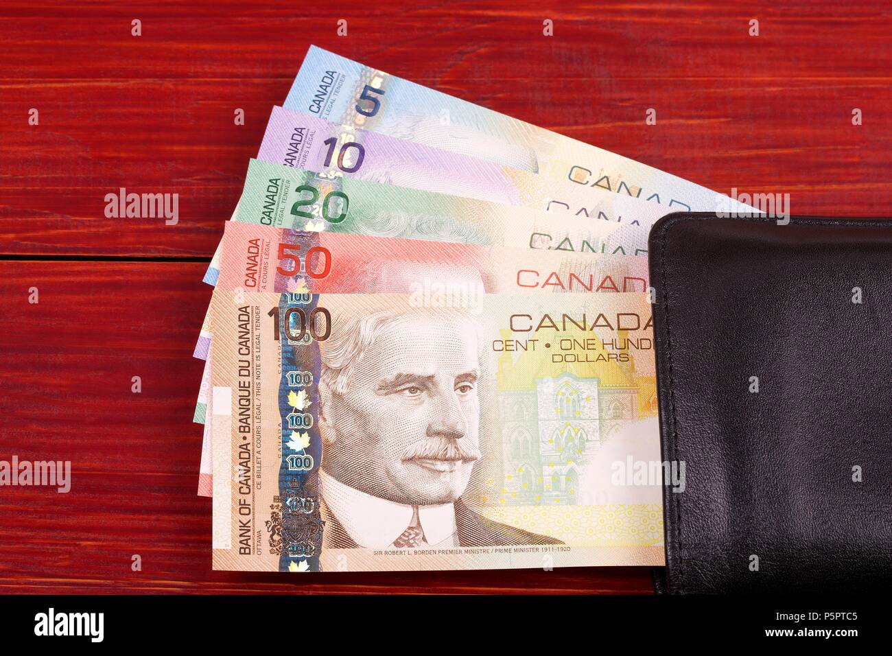Canadian money in the black wallet Stock Photo - Alamy