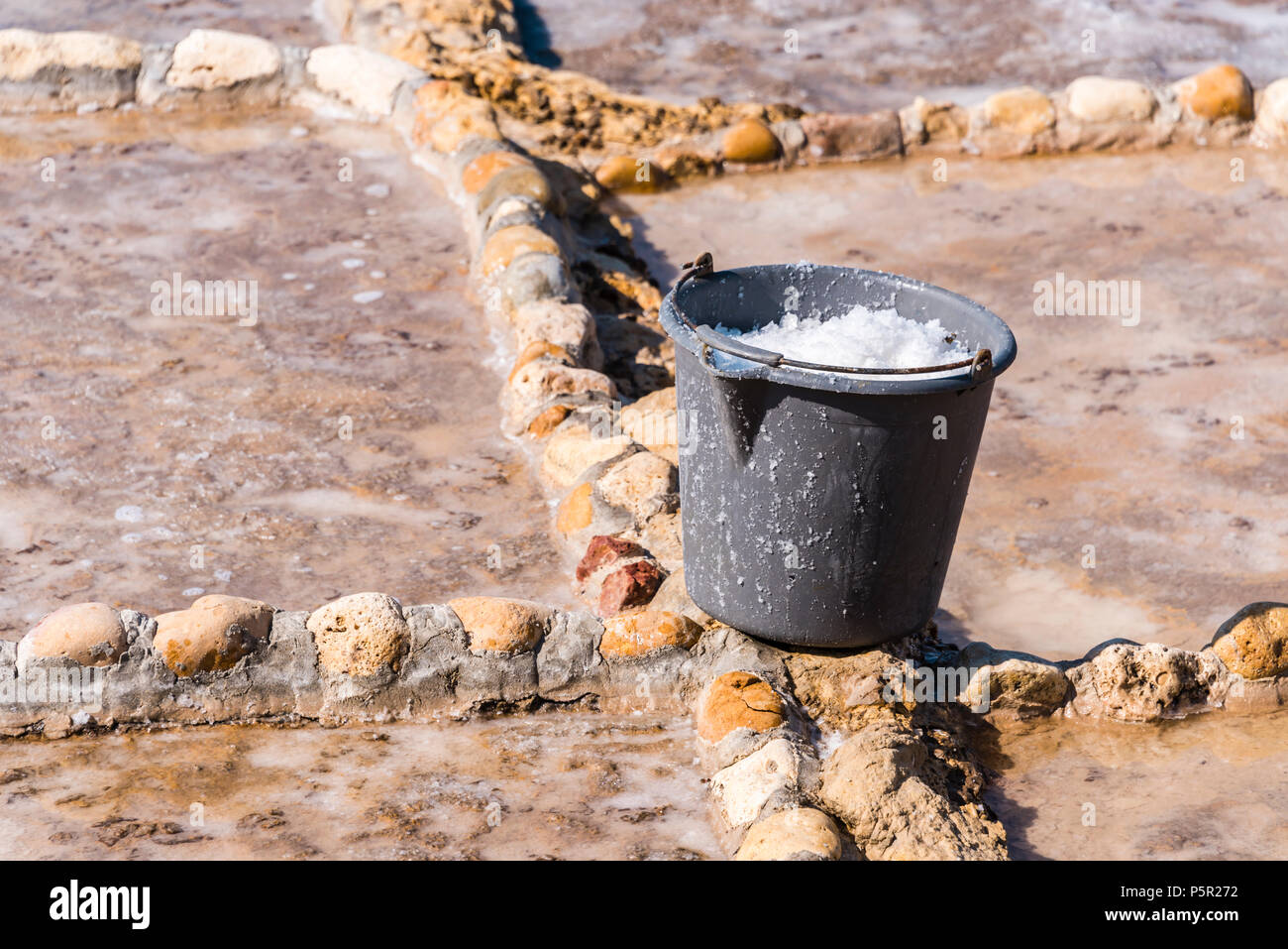Harvesting sea salt from the ancient salt pans in Marsalforn, Gozo ...