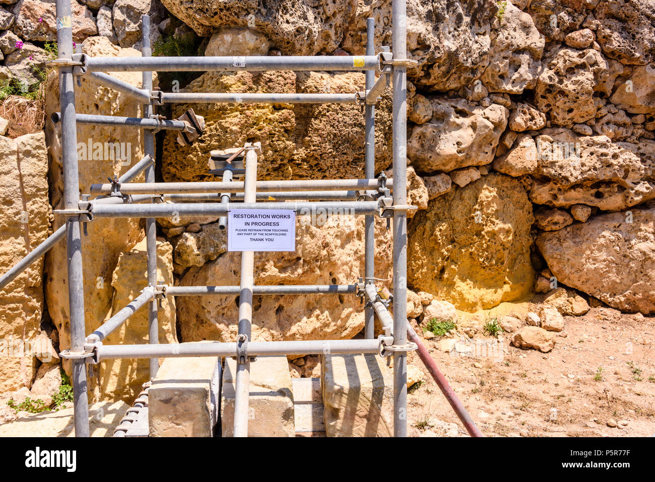 Scaffold poles hold up a wall of the ancient megalithic temple of ...