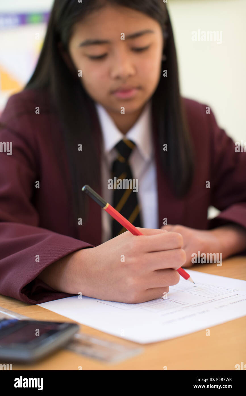 Female Pupil In Uniform Taking Multiple Choice Examination Paper Stock ...