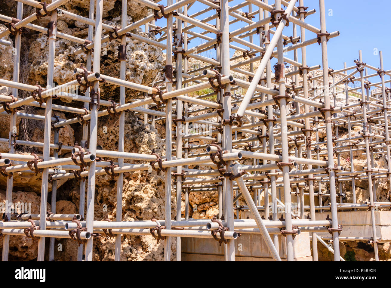 Scaffold poles hold up a wall of the ancient megalithic temple of ...