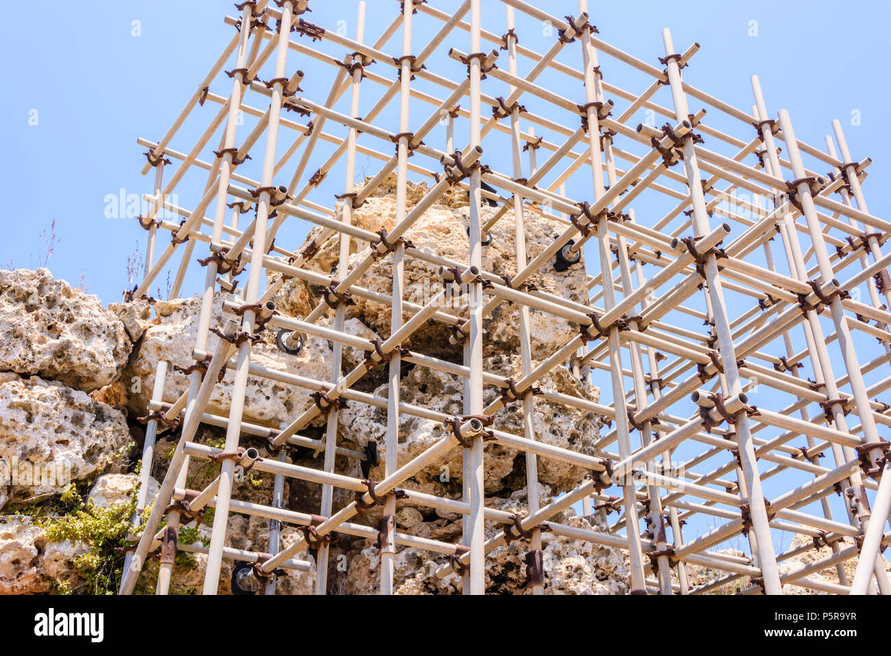 Scaffold poles hold up a wall of the ancient megalithic temple of ...