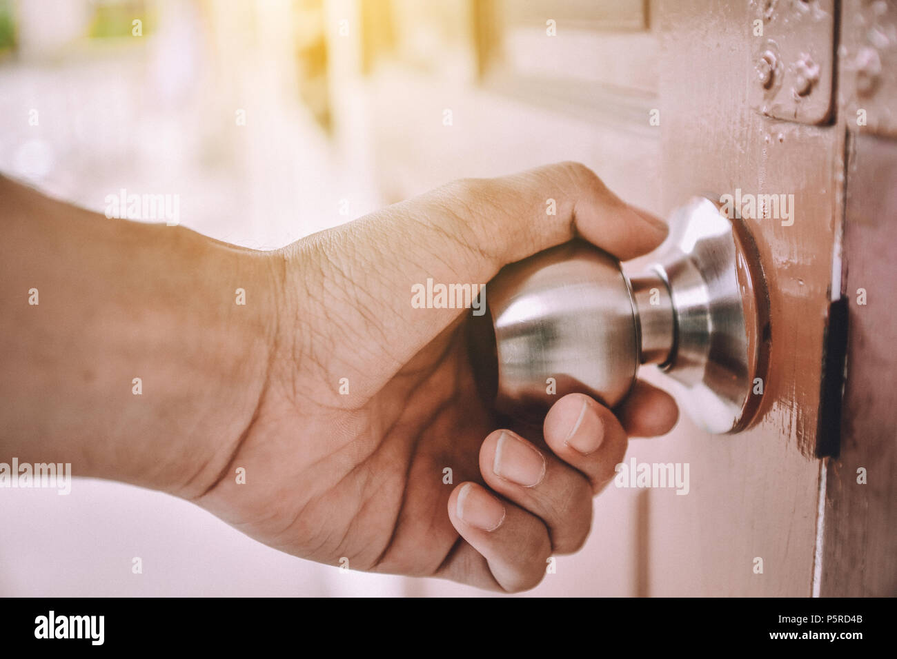 Hand opening the door in house Stock Photo - Alamy