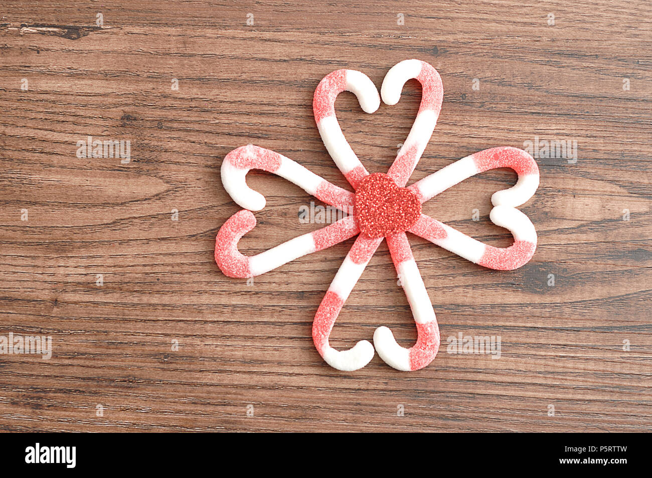 A flower pattern made out of candy canes packed in heart shapes with a ...