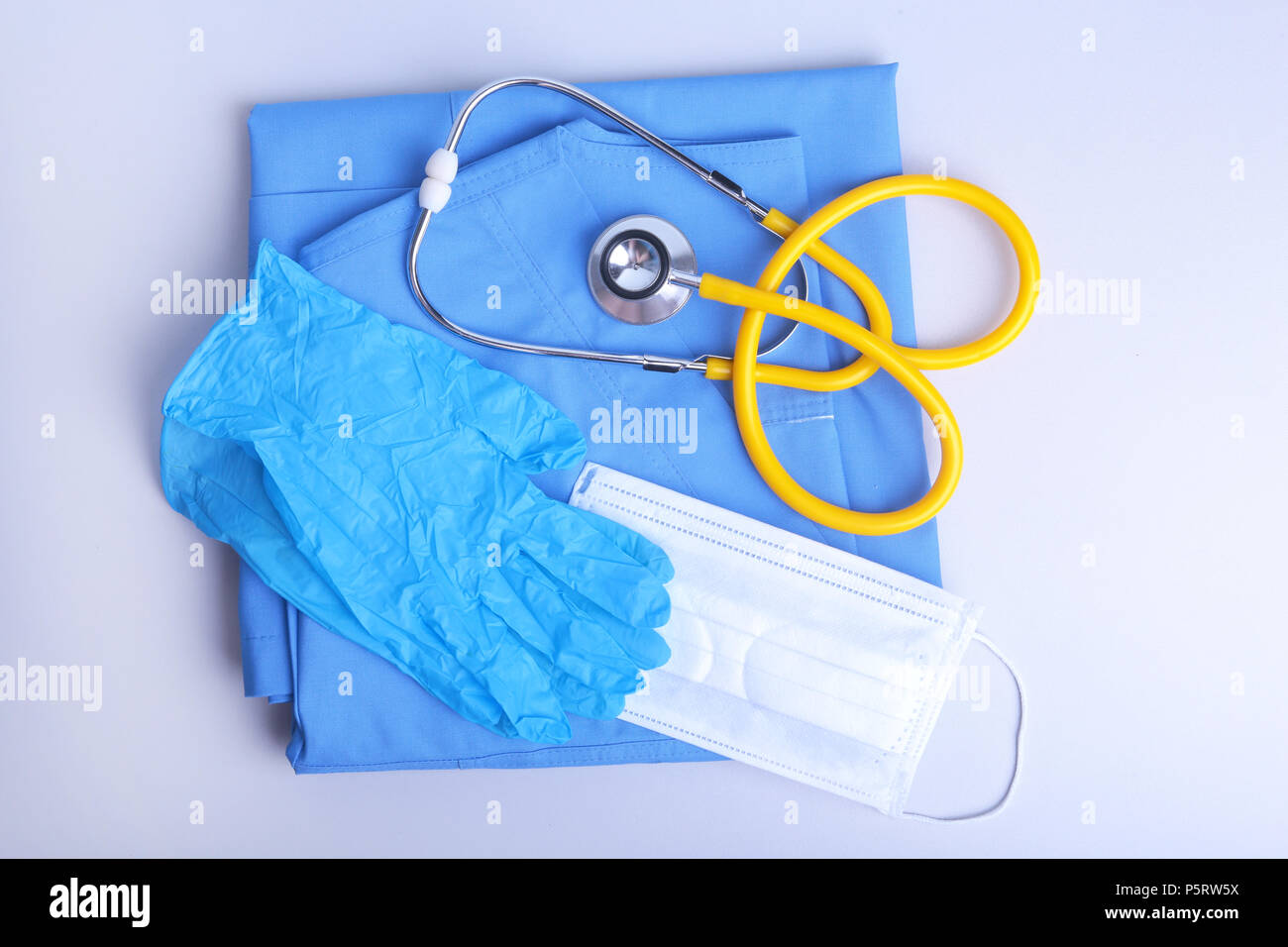 Medical stethoscope head lying on blue doctor uniform closeup. Medical ...