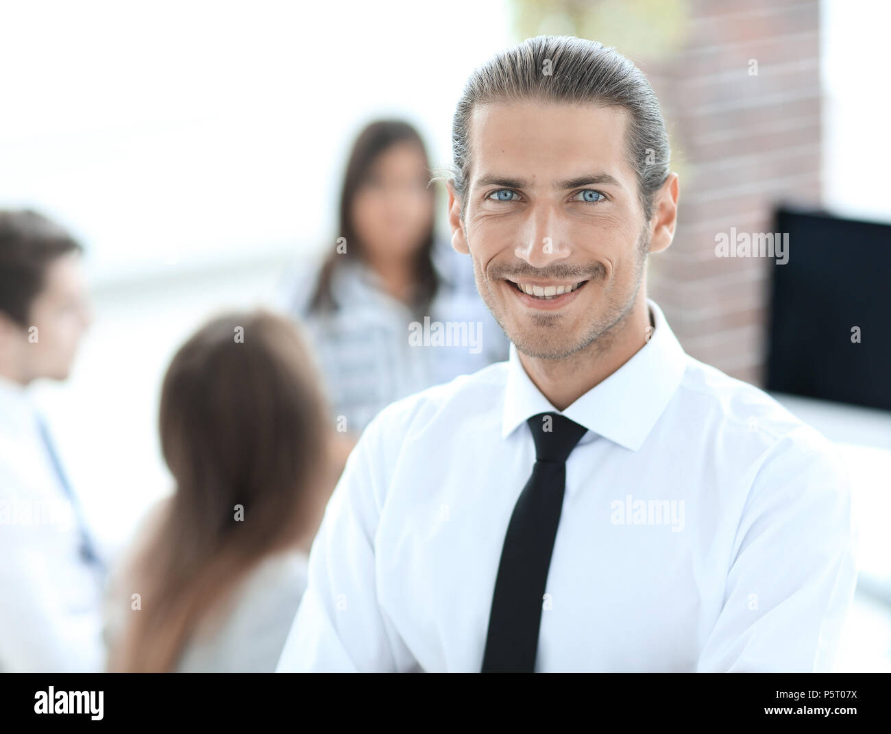 successful young business men on blurred background Stock Photo - Alamy