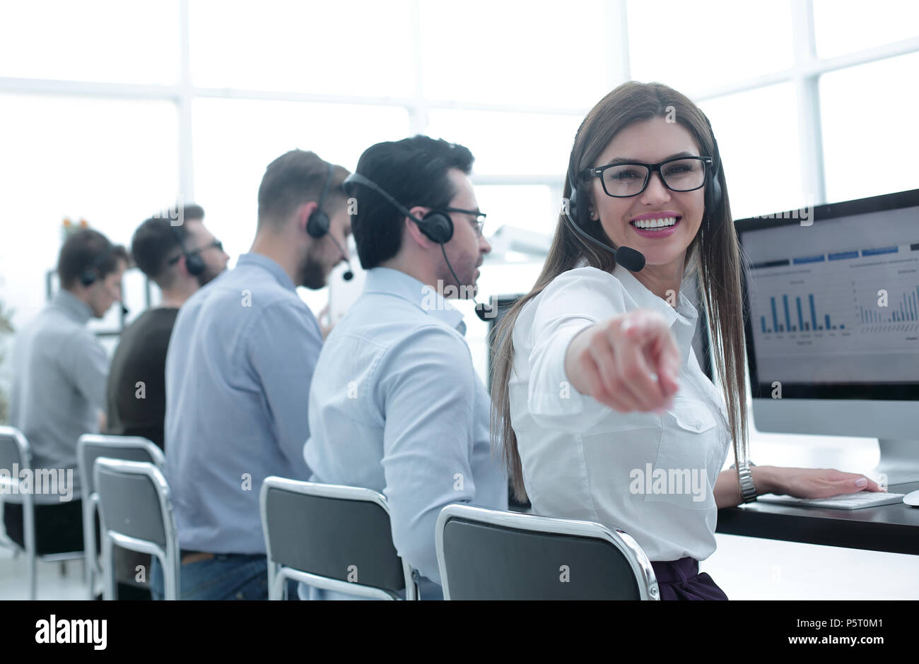 smiling business center employee pointing a finger at you Stock Photo ...