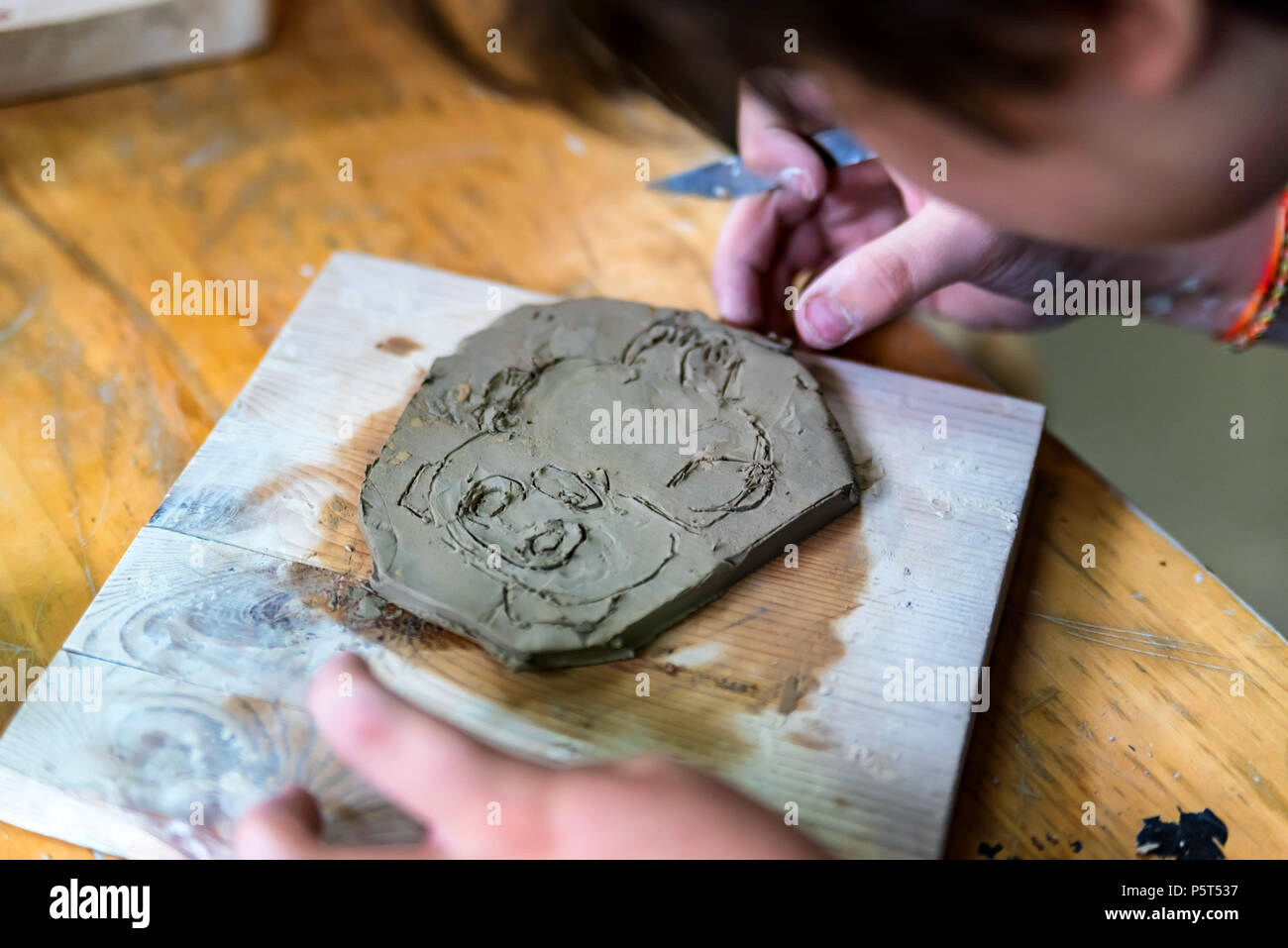 Pottery workshop. hands make print on clay Stock Photo - Alamy