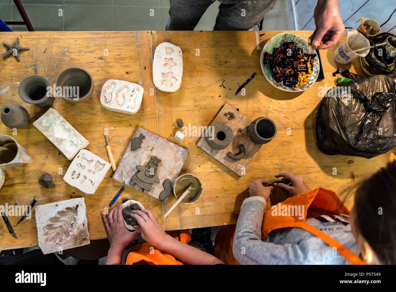 Pottery workshop. hands make print on clay Stock Photo - Alamy