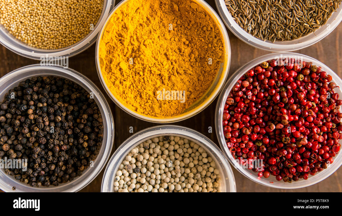 Various colorful spices in plastic containers Stock Photo - Alamy