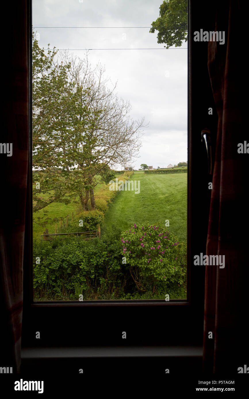 modern window looking out onto rural fields in the lake district ...