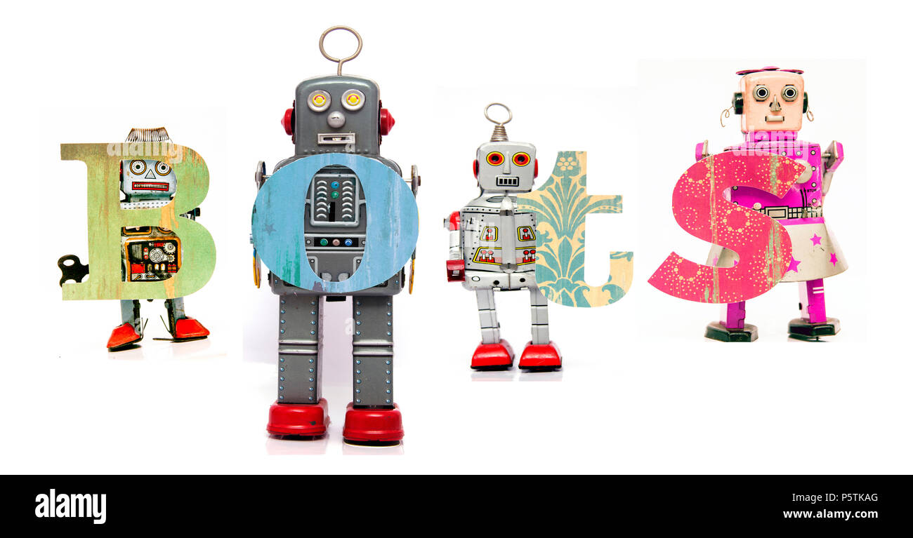 retro tin robot toys hold up the word BOTS isolated on white Stock ...