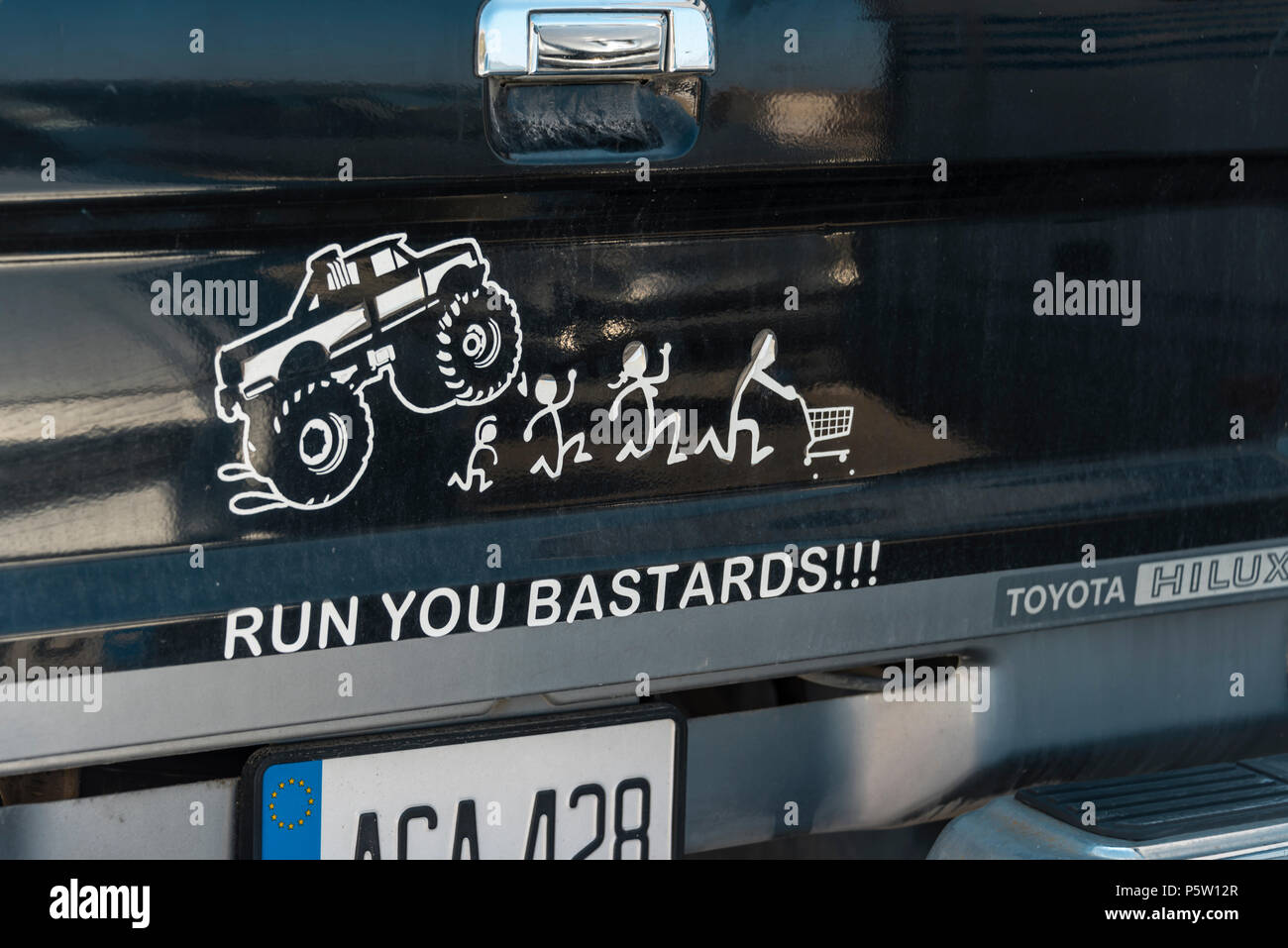 Bumper sticker on a Toyota Hilux pickup truck showing a pickup trying ...