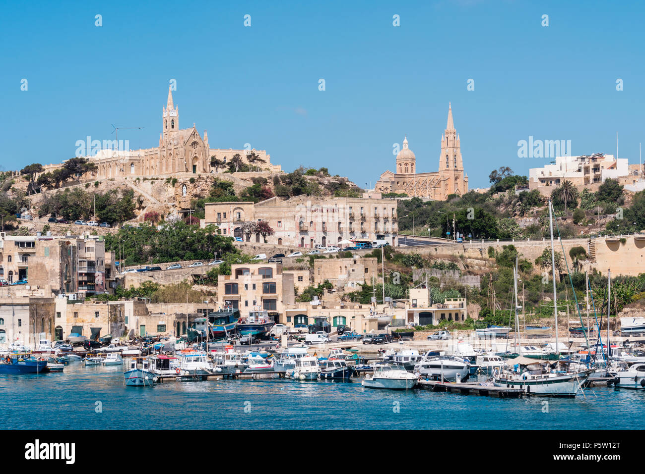 Mgarr Parish Church sitting on a hill above Mgarr town and harbour, the ...
