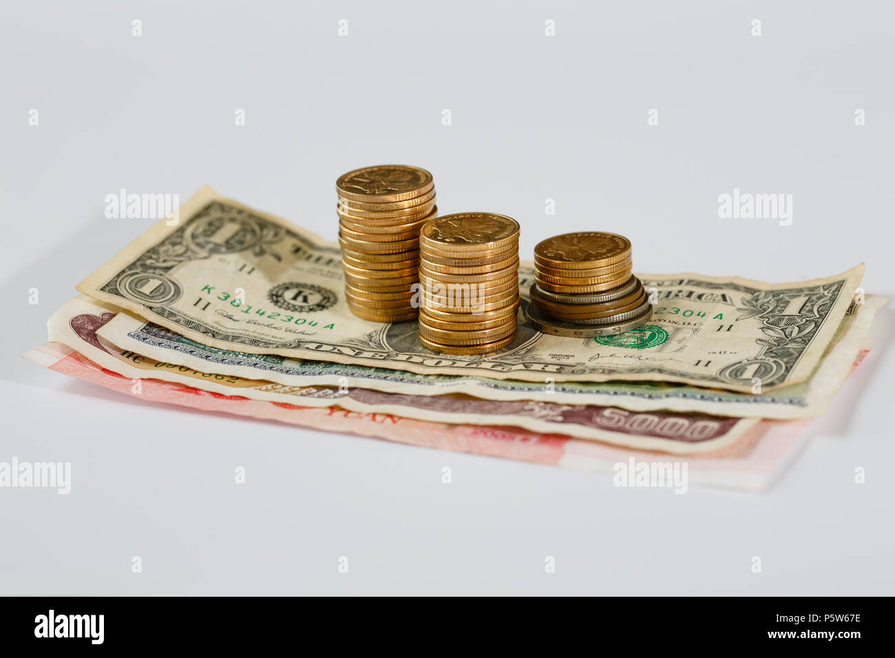 Banknotes and coins from various countries are on a white background ...