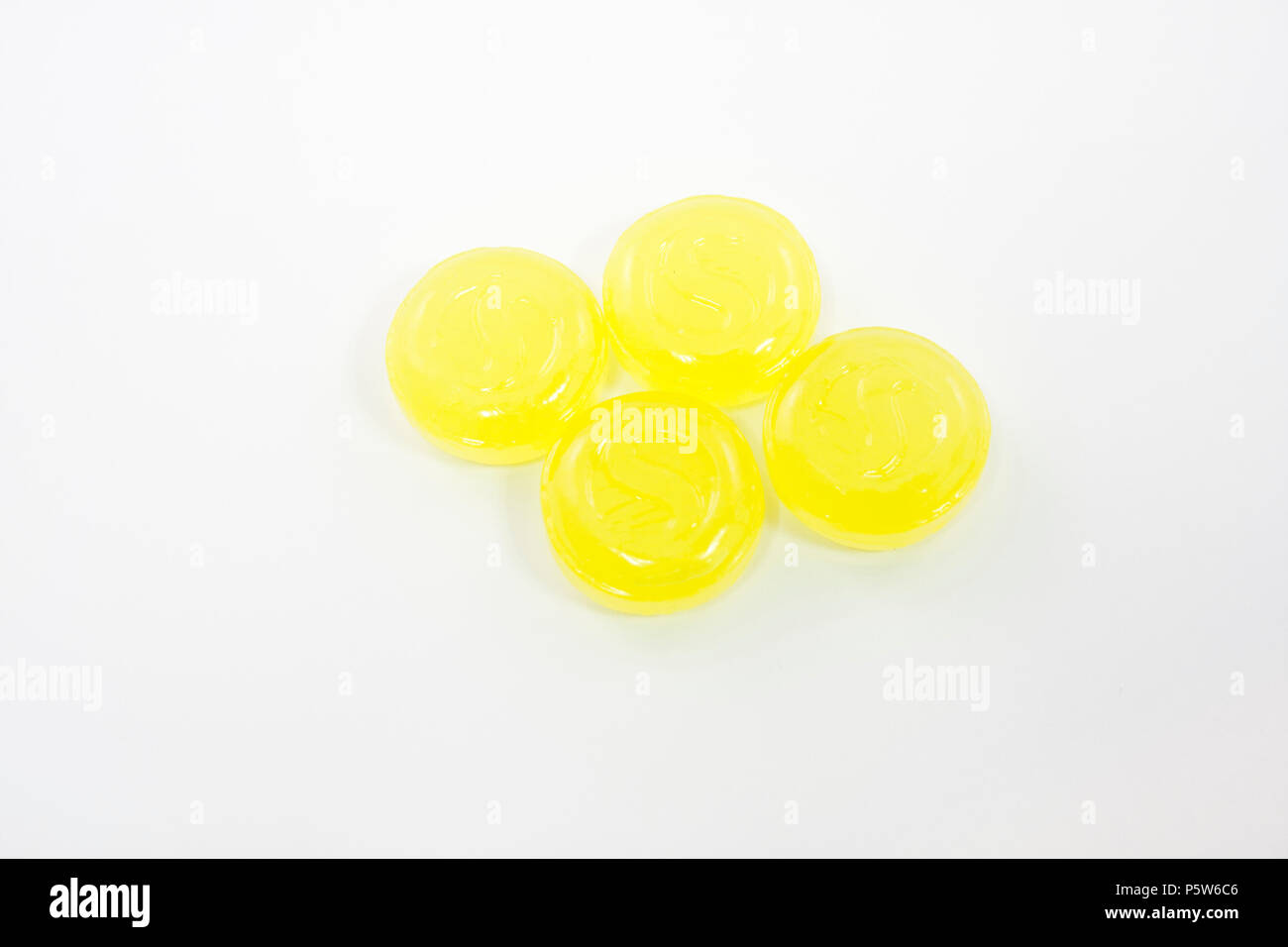 yellow cough sweets isolated on white background Stock Photo - Alamy